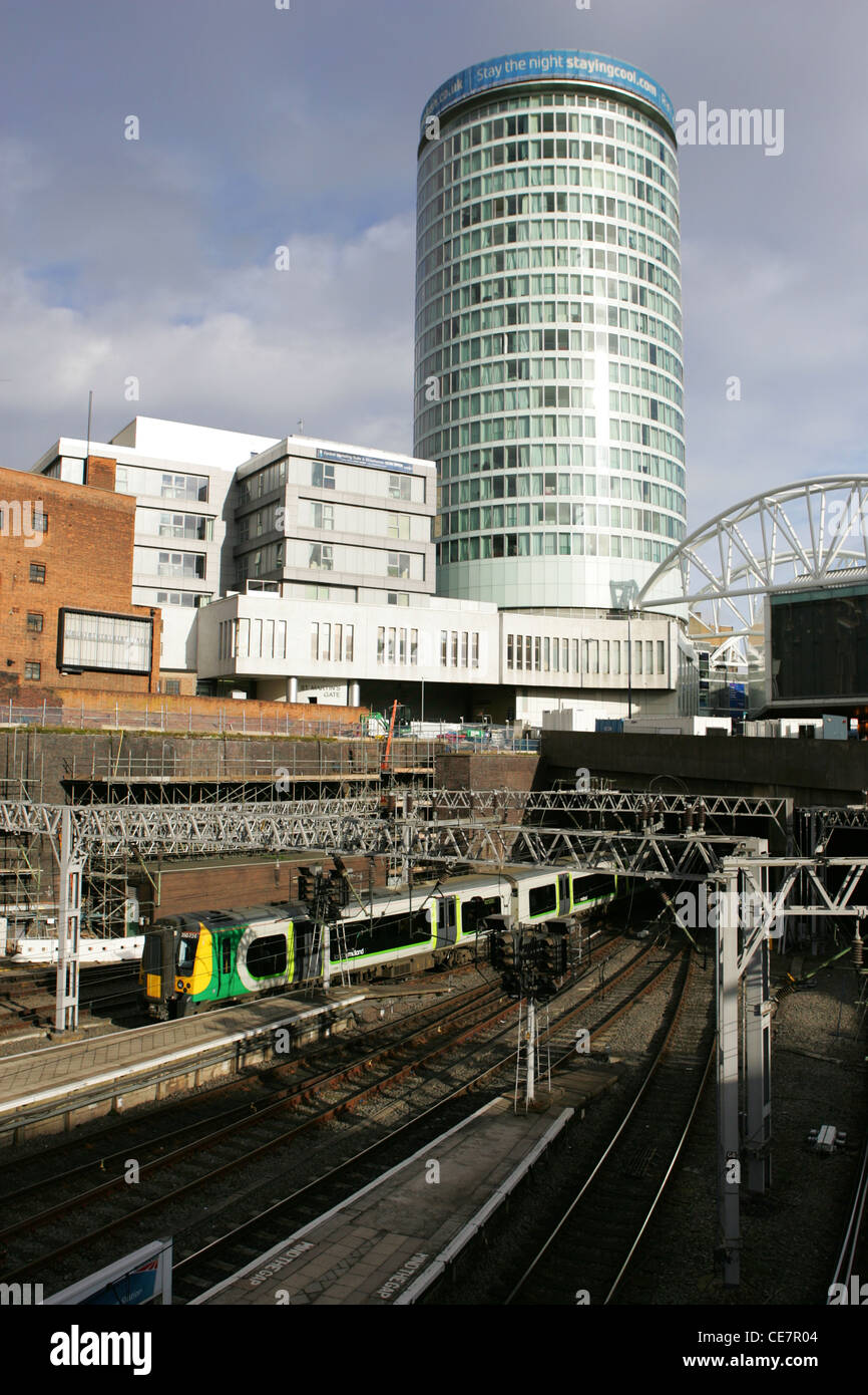 london midland class 350 heads into birmingham new street under the showow of the iconic rotunda ...