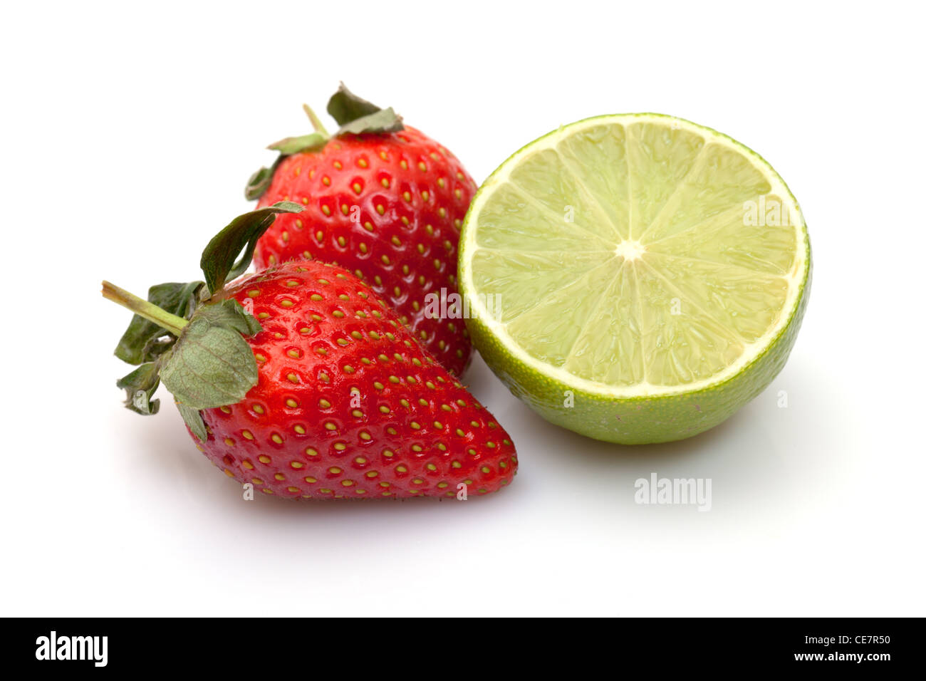 Strawberries with lime closeup over white background Stock Photo - Alamy