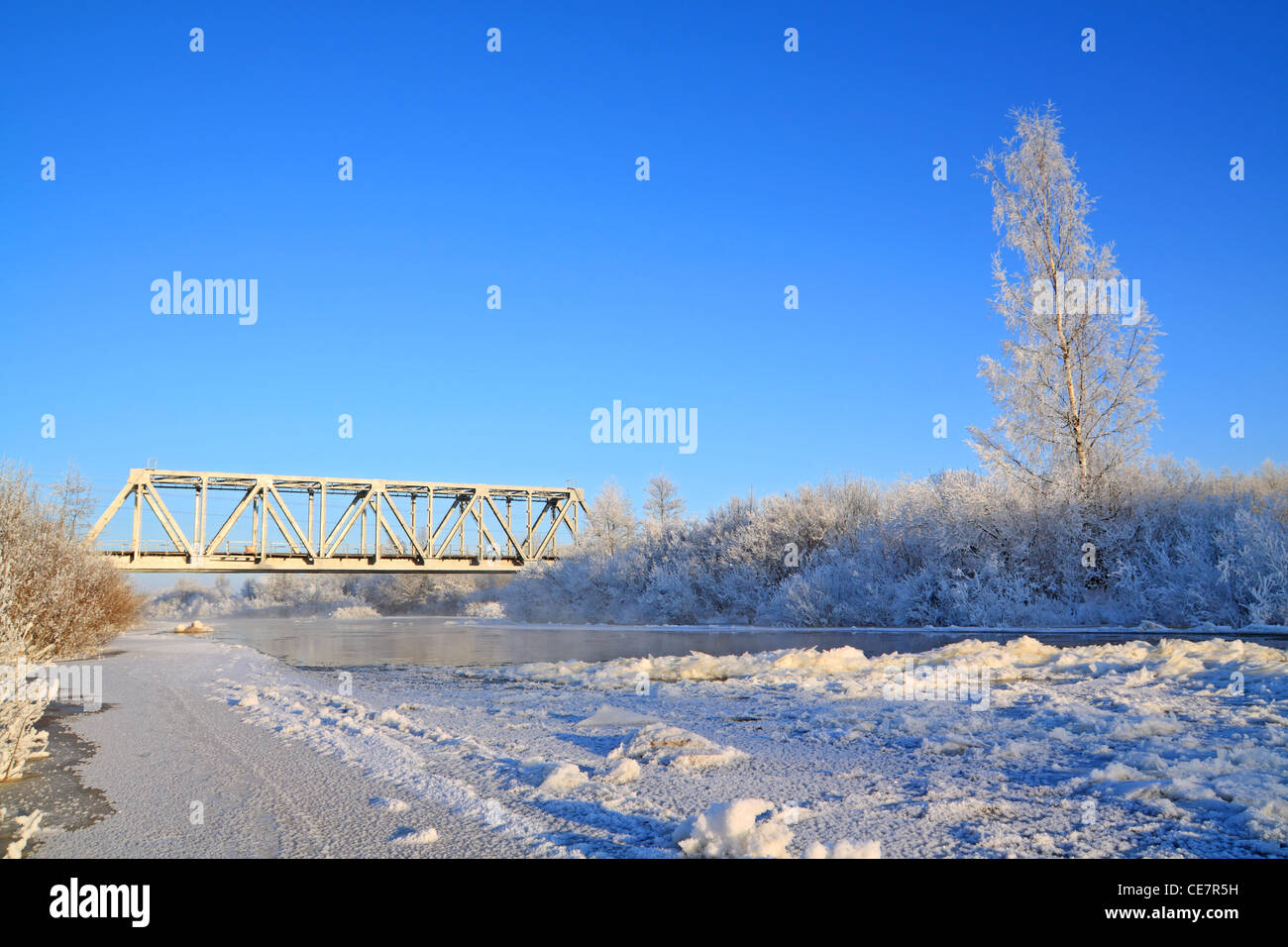 railway bridge on freeze river Stock Photo - Alamy