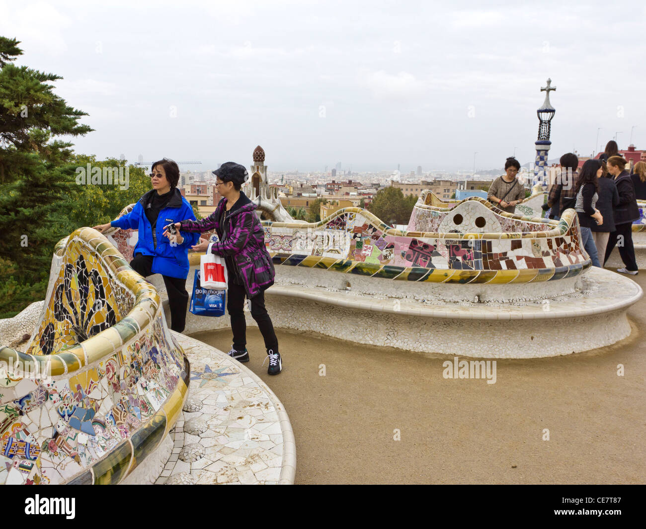 Tourists visiting Park Guell garden complex in Barcelons, Spain ...