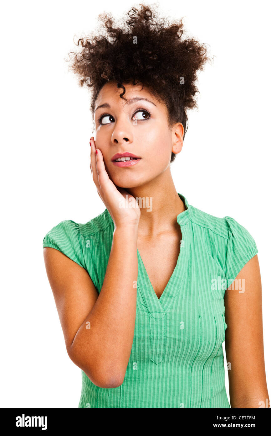 Beautiful woman thinking hand on cheek looking up. Studio shot with ...