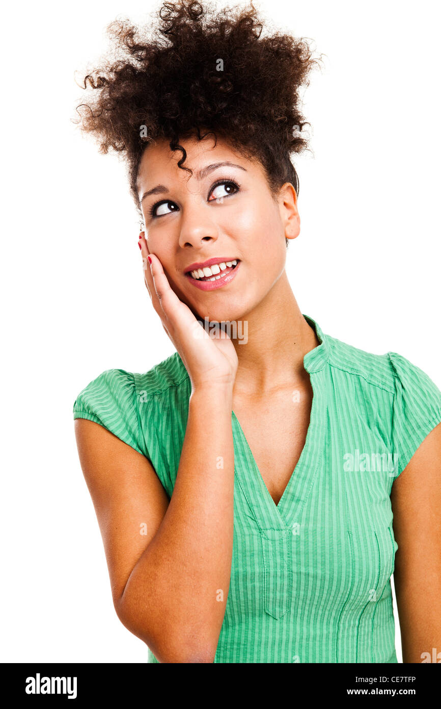 Beautiful woman thinking hand on cheek looking up. Studio shot with ...
