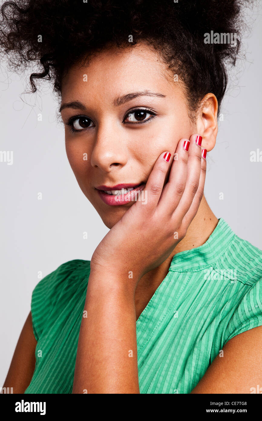 Portrait of a beautiful woman with hand on cheek. Studio shot Stock ...