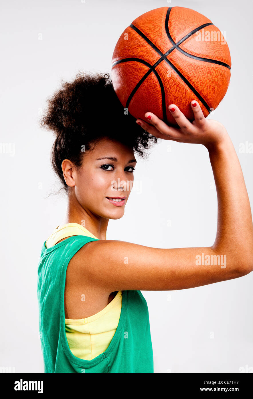 Beautiful young athletic woman with basketball. Studio shot Stock Photo ...