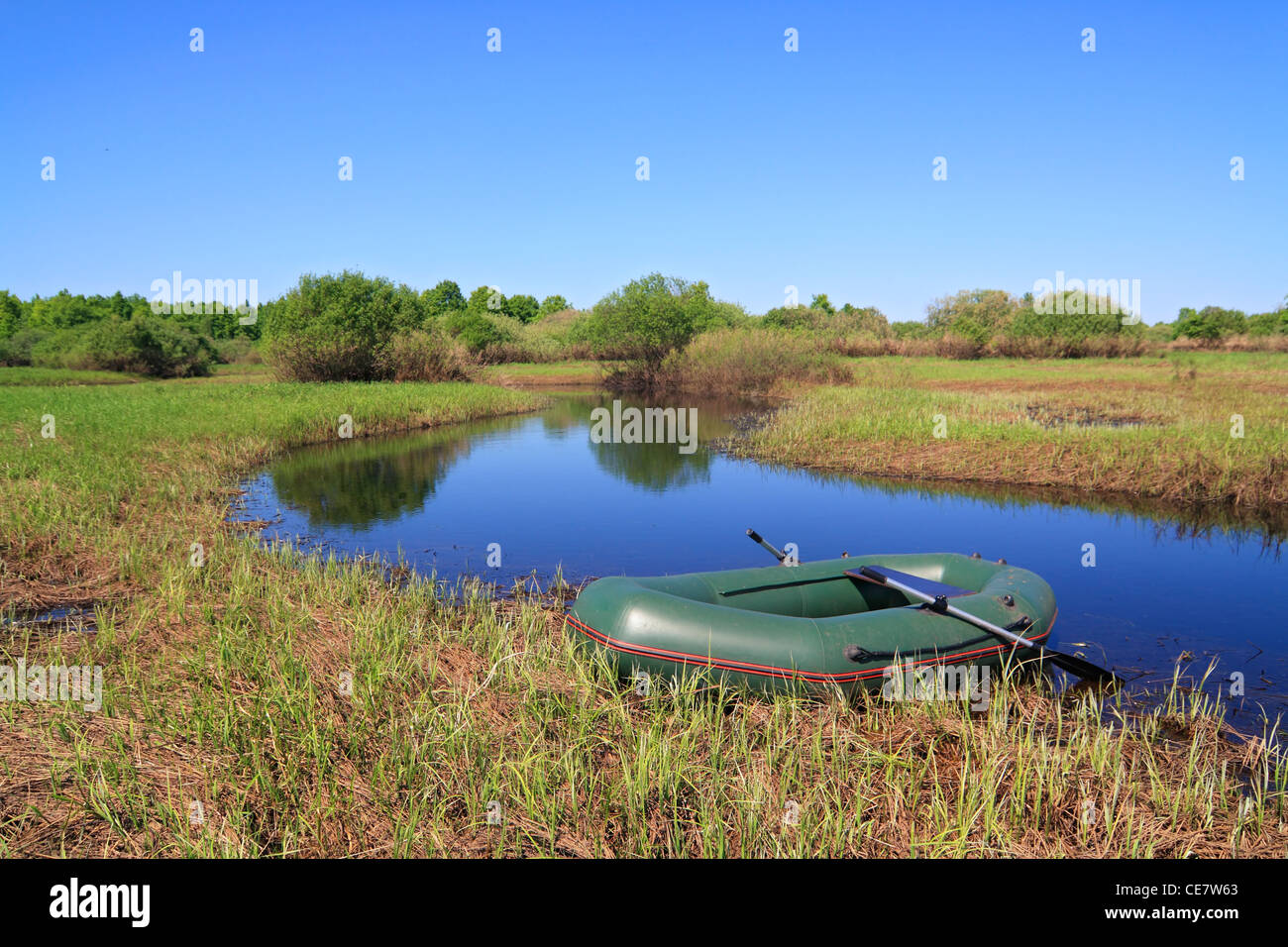 green boat on small river Stock Photo - Alamy