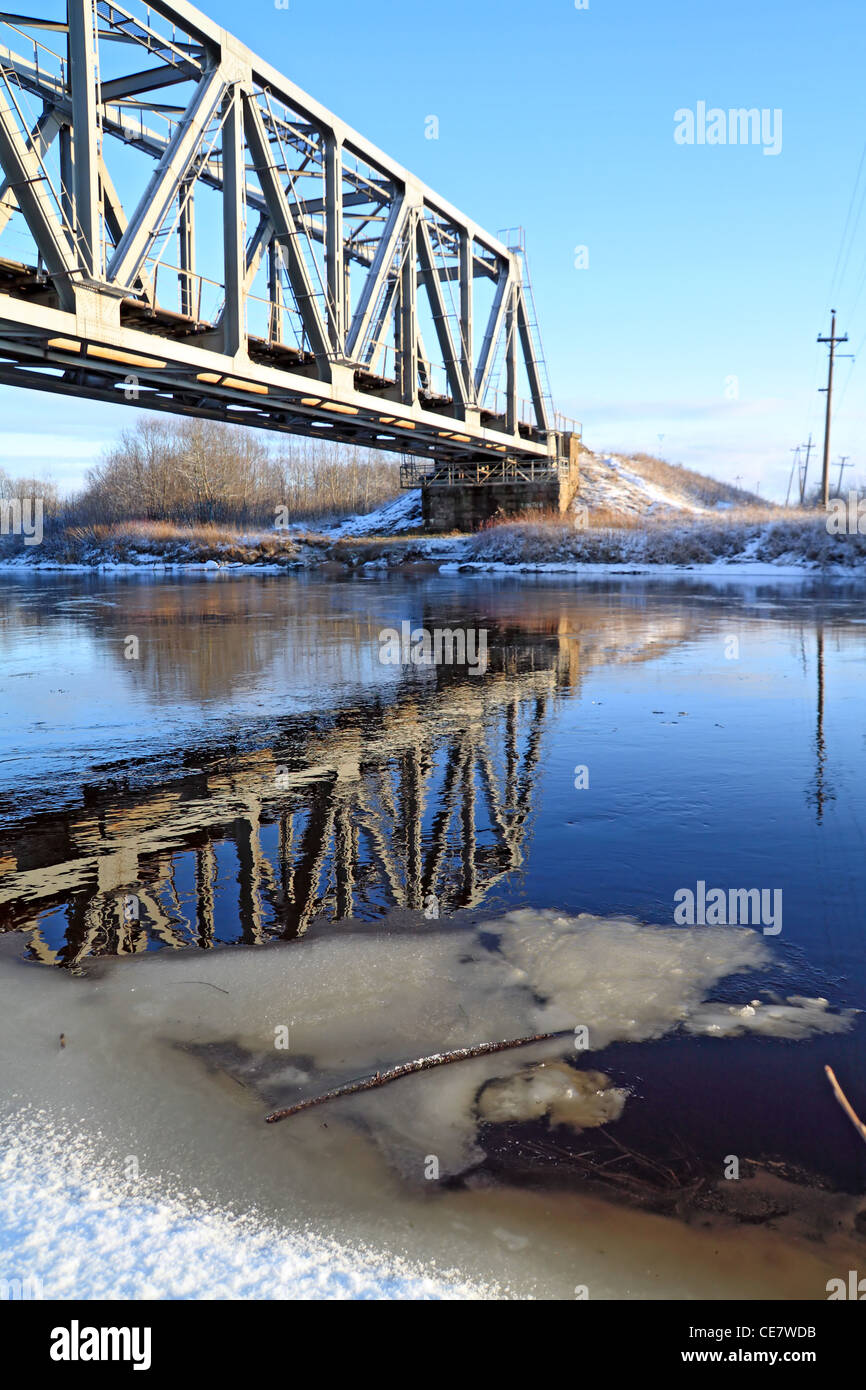 railway bridge through small river Stock Photo - Alamy