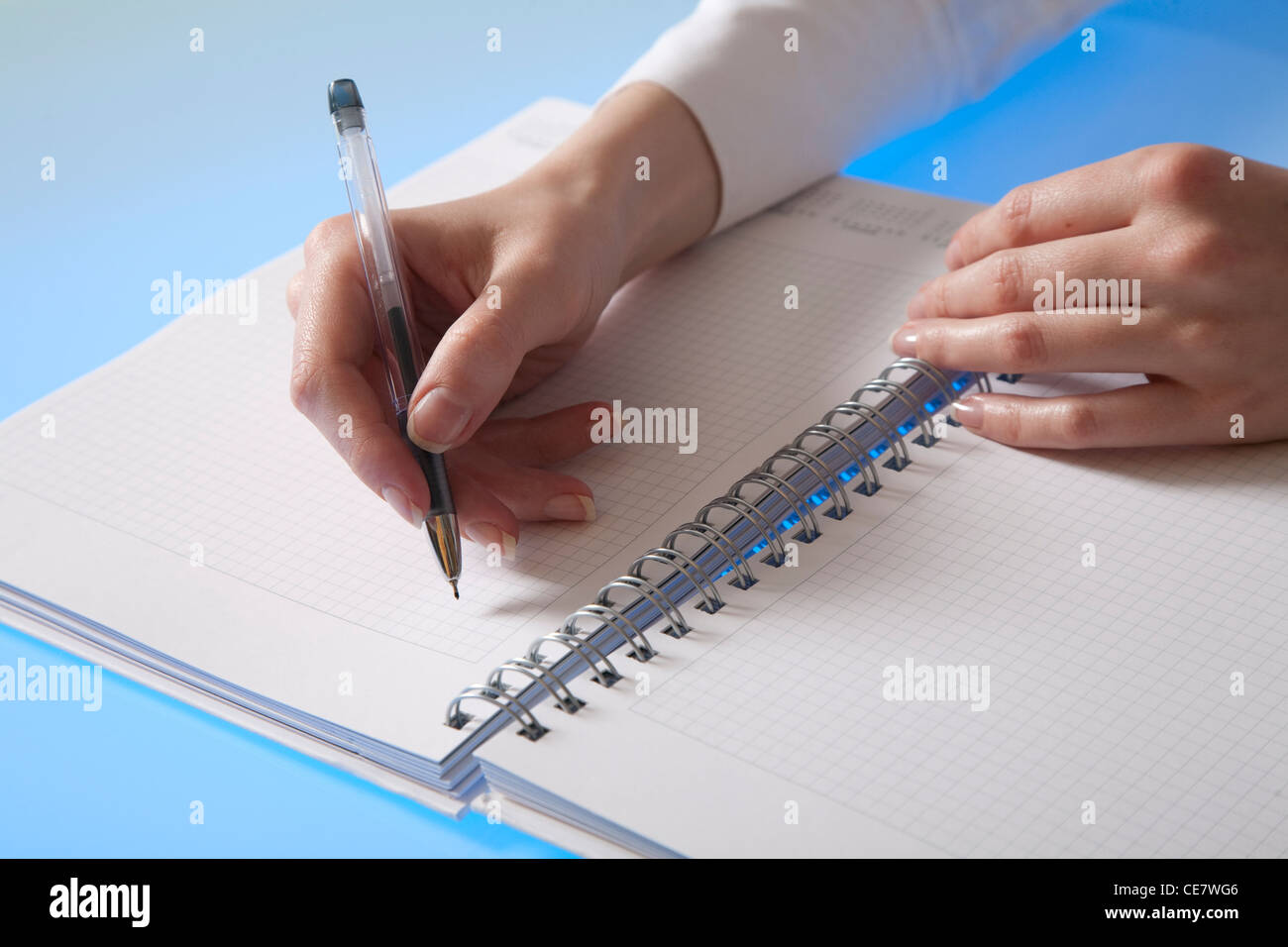 Woman's hand starting to make notes in a diary on a conference Stock ...