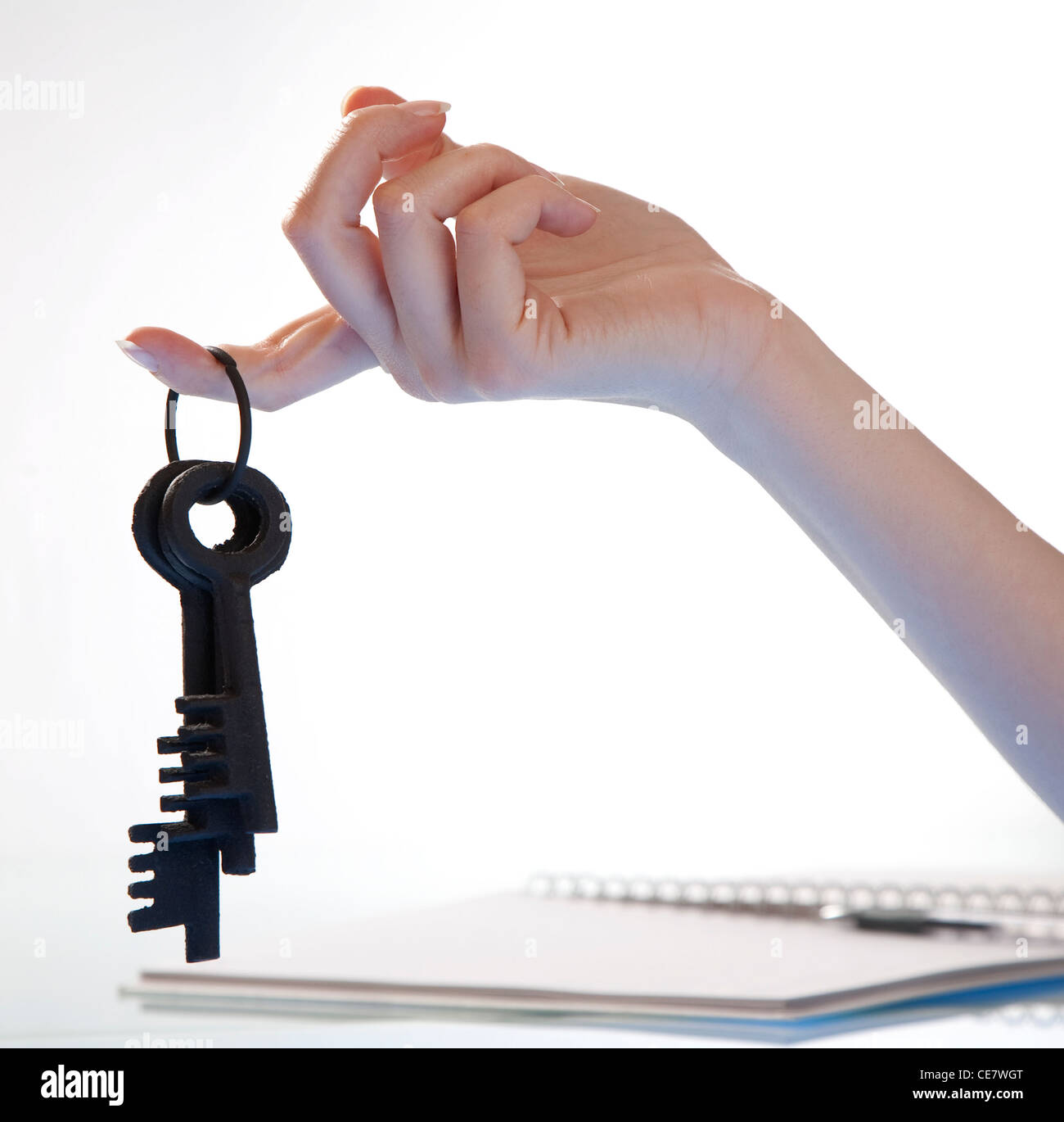Woman's hand gently holding a bunch of retro keys Stock Photo - Alamy