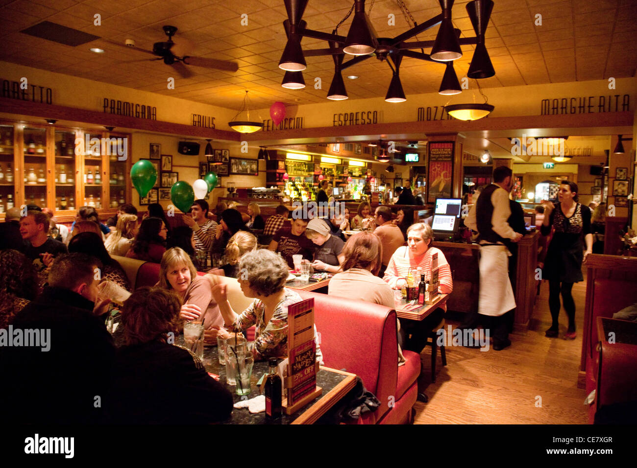 People eating inside Frankie & Bennys restaurant bar, Cambridge UK ...