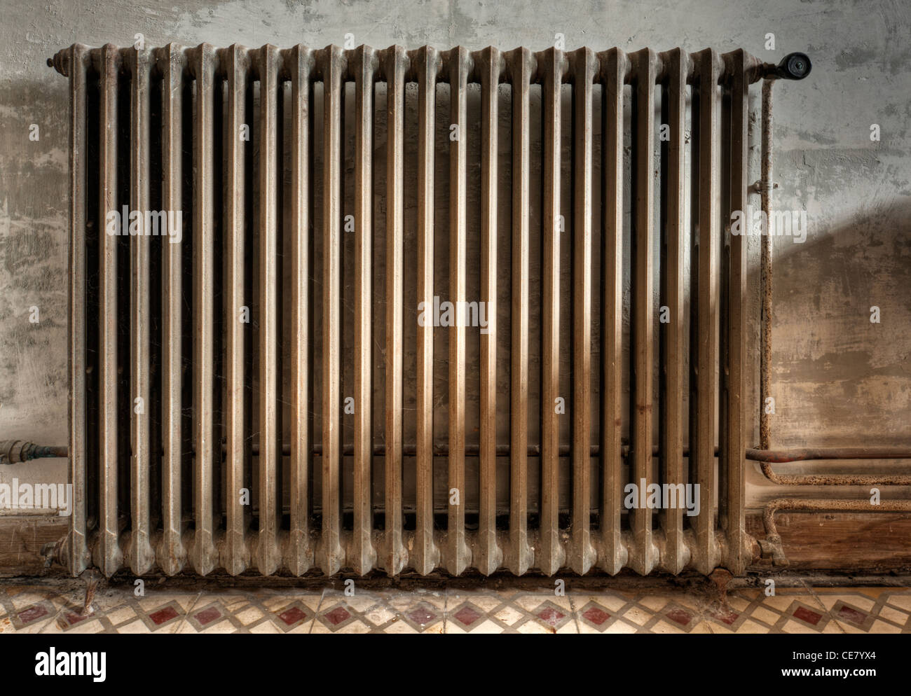Old radiator against weathered wall, France Stock Photo - Alamy