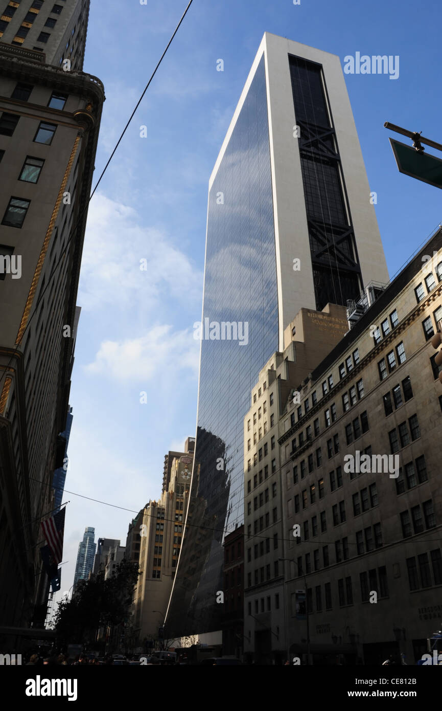 Blue sky portrait skyscrapers, sloping glass facade Solow Building ...