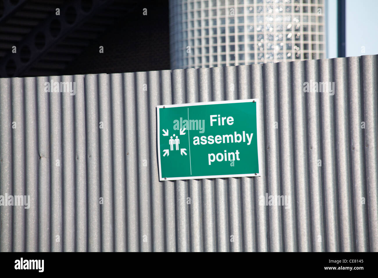 Fire assembly point sign on corrugated iron outside building Stock ...