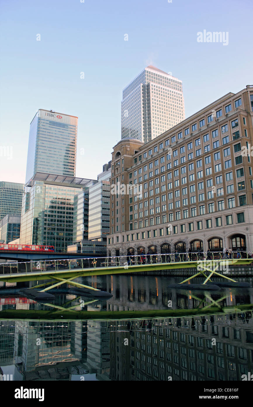 Modern tower blocks and pontoon bridge at Canary Wharf Docklands London ...
