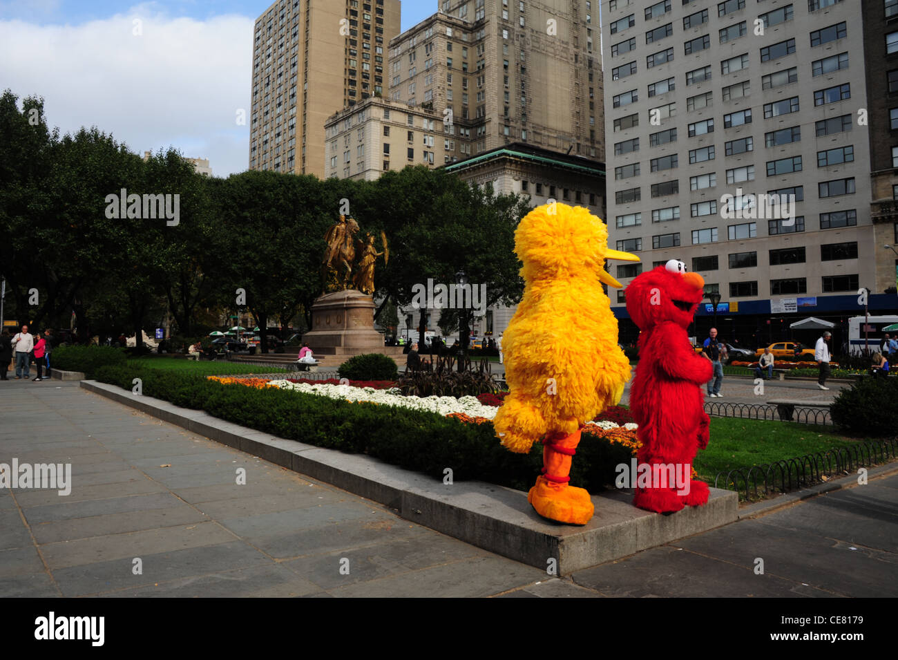 Two Sesame Street entertainers (Big Bird Elmo) standing corner flower ...