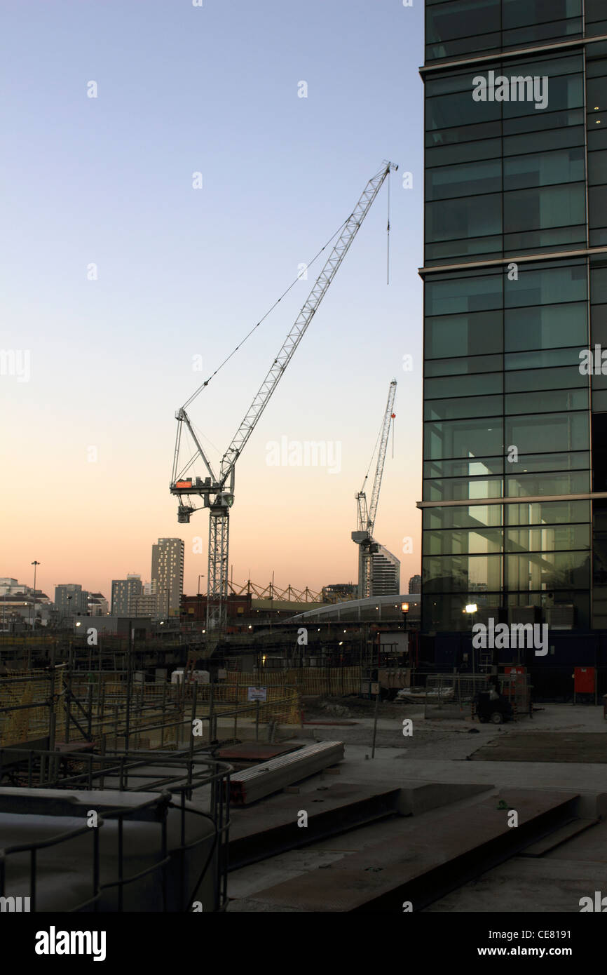 Cranes and Modern tower blocks Canary Wharf Docklands London England UK ...