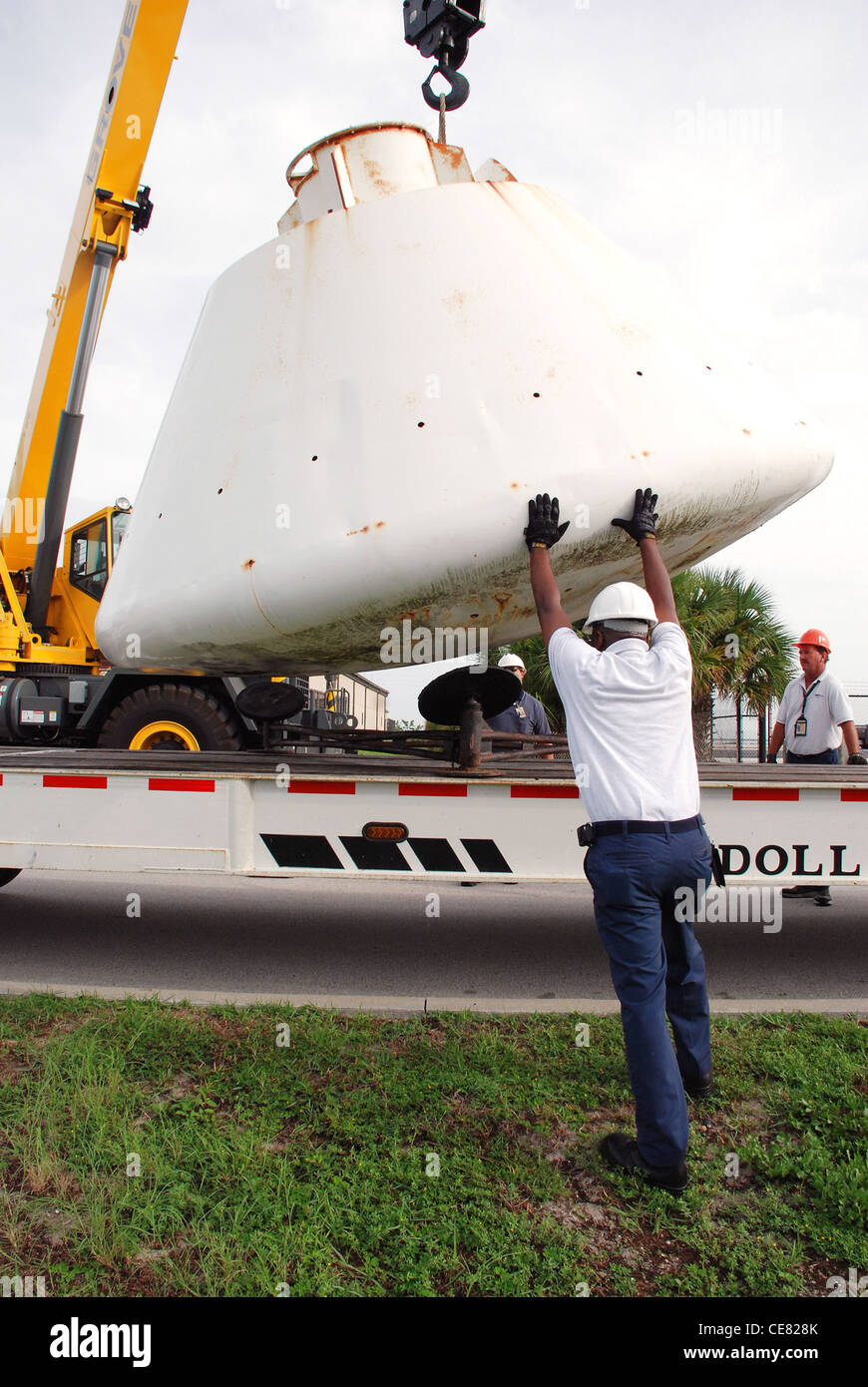 Workers help guide the 9,000-pound Apollo Boilerplate #1206 capsule ...