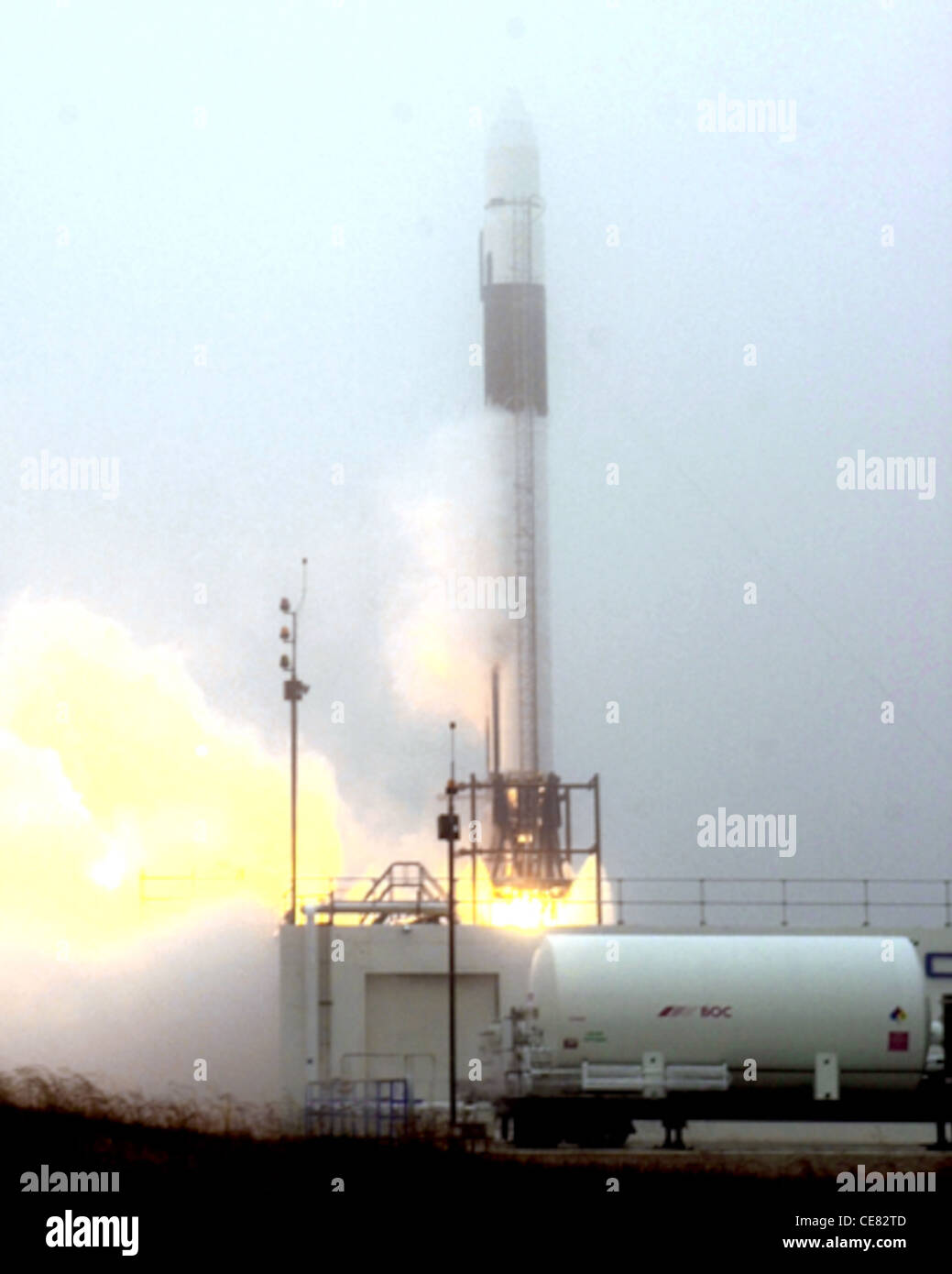The main engine of the Falcon I rocket ignites during a full-wet dress ...