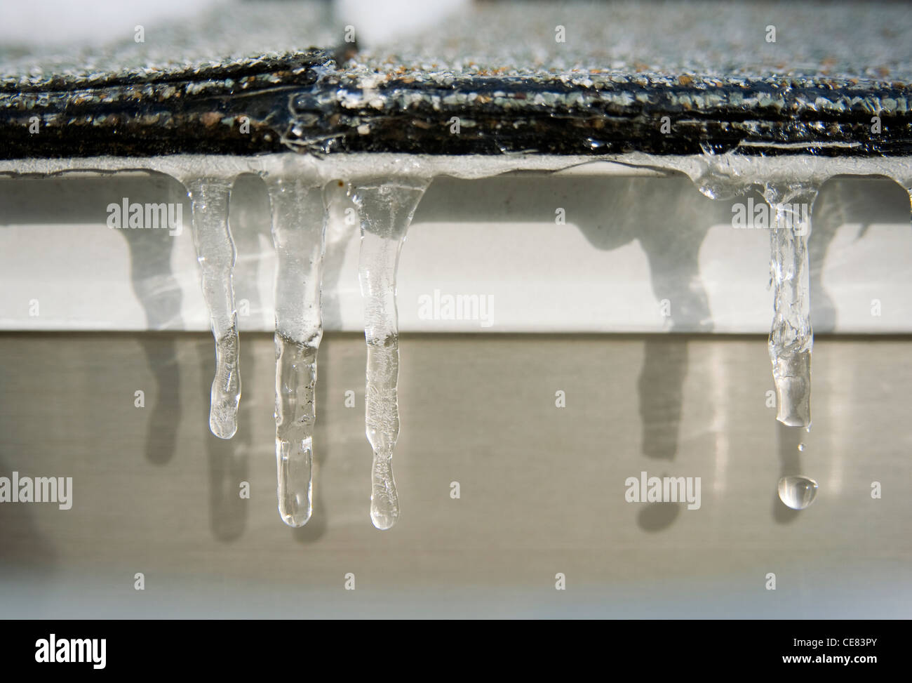 Icicles on roof melting Stock Photo - Alamy Icicles on roof melting Stock Photo - Alamy
