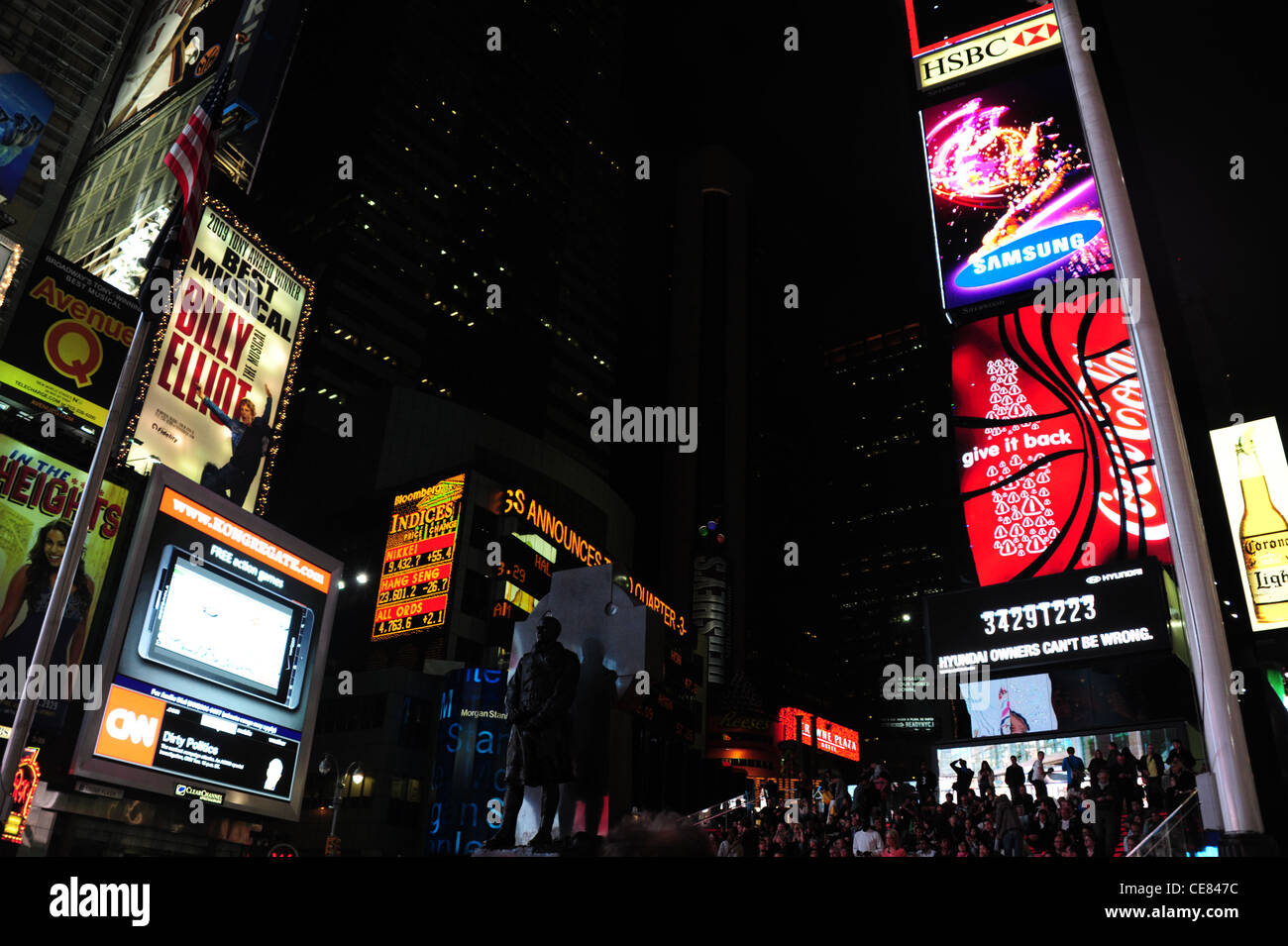 Night neon view electronic billboards, Father Patrick Duffy Statue, people TKTS roof steps, 7th ...