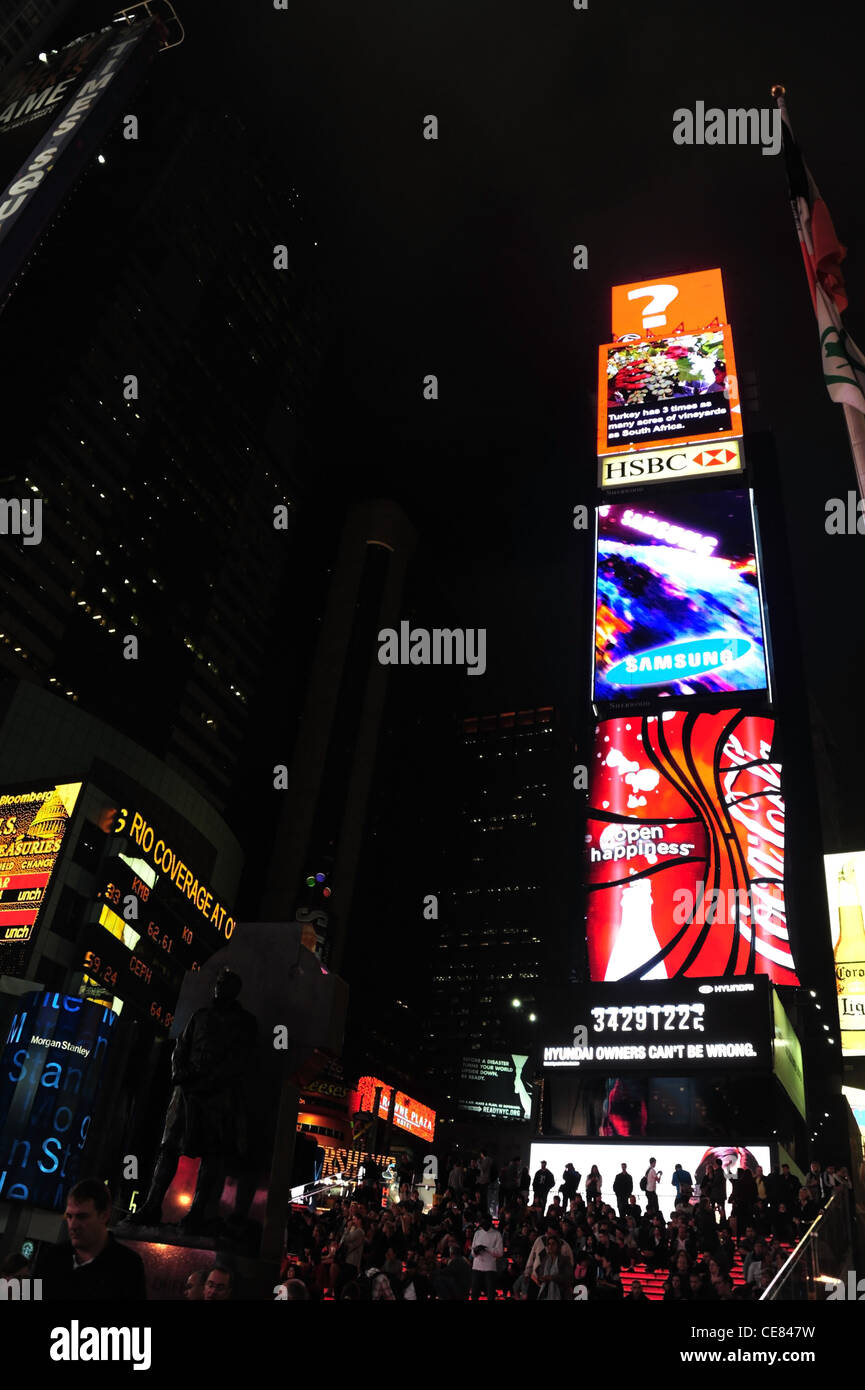 Night neon portrait Father Duffy Statue, people TKTS roof steps, electronic billboards, Duffy ...