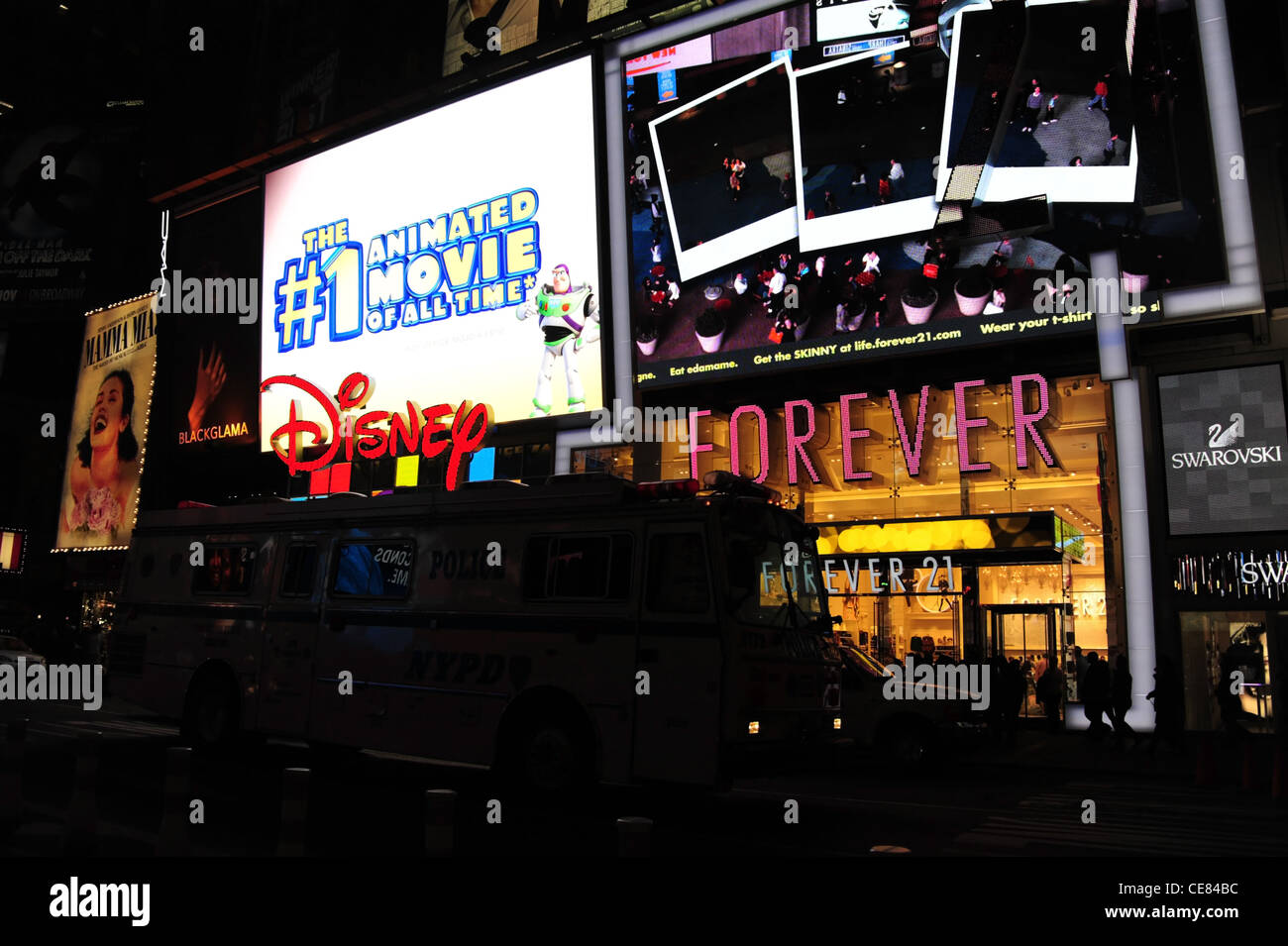 Night neon billboards view double-deck bus passing Disney Store ...