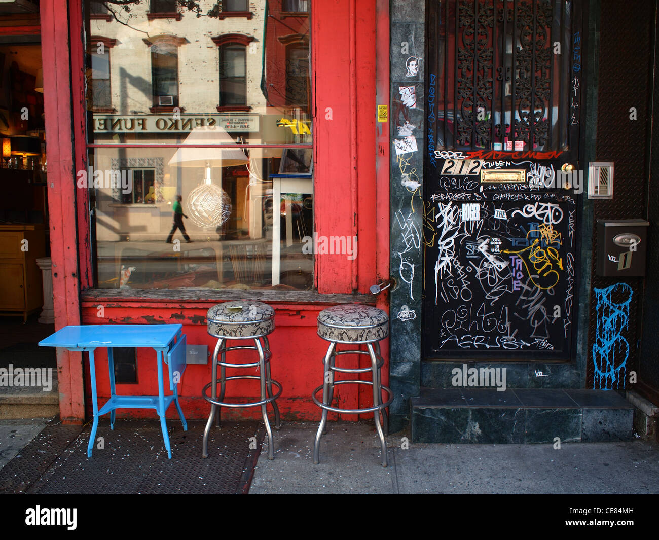Colorful shop facade with window reflection and graffiti, Brooklyn, New ...