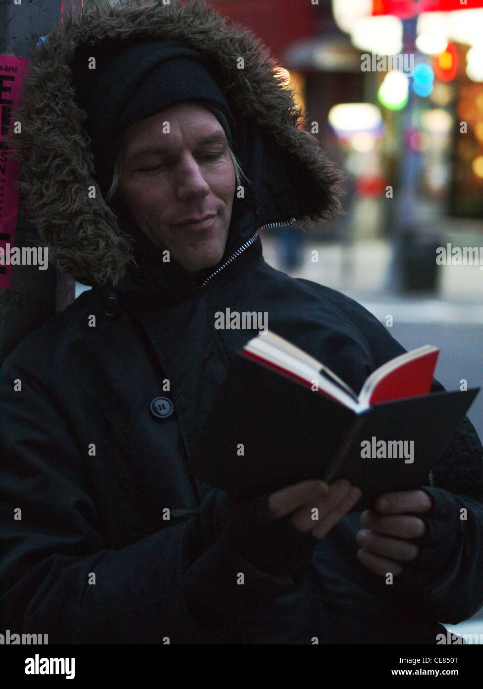 Bookseller on street reading book, Brooklyn, New York Stock Photo - Alamy