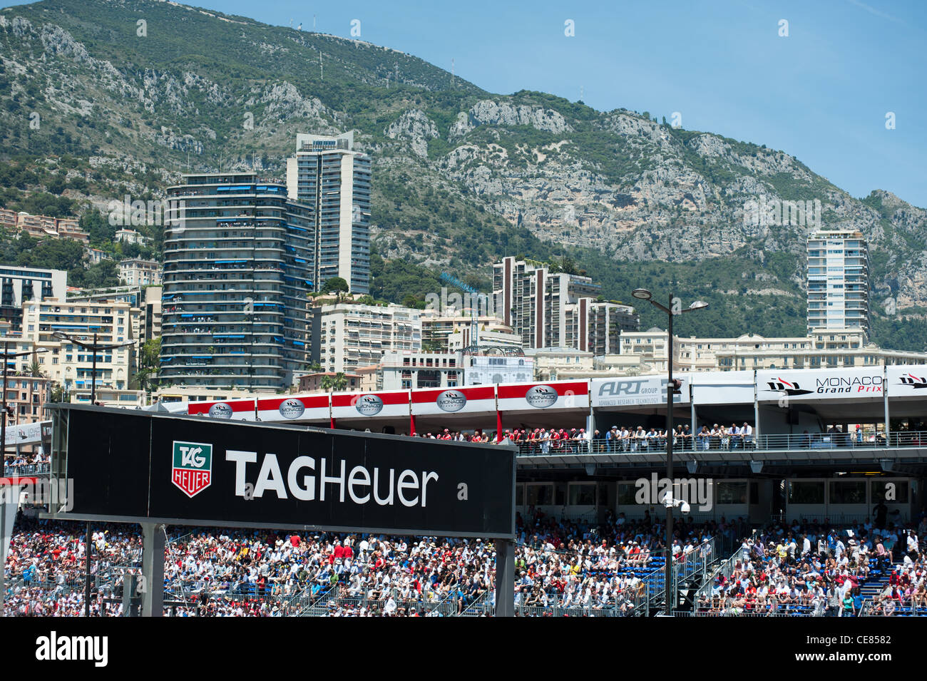 Crowds of spectators watching the 2011 Monaco Grand Prix, with the town ...