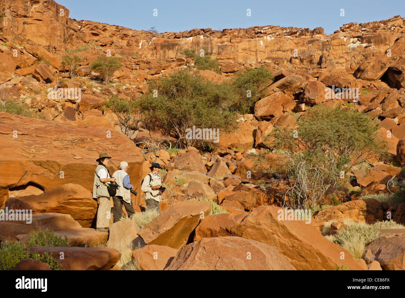 Tourists visiting San rock art site, Twyfelfontein, Namibia Stock Photo ...