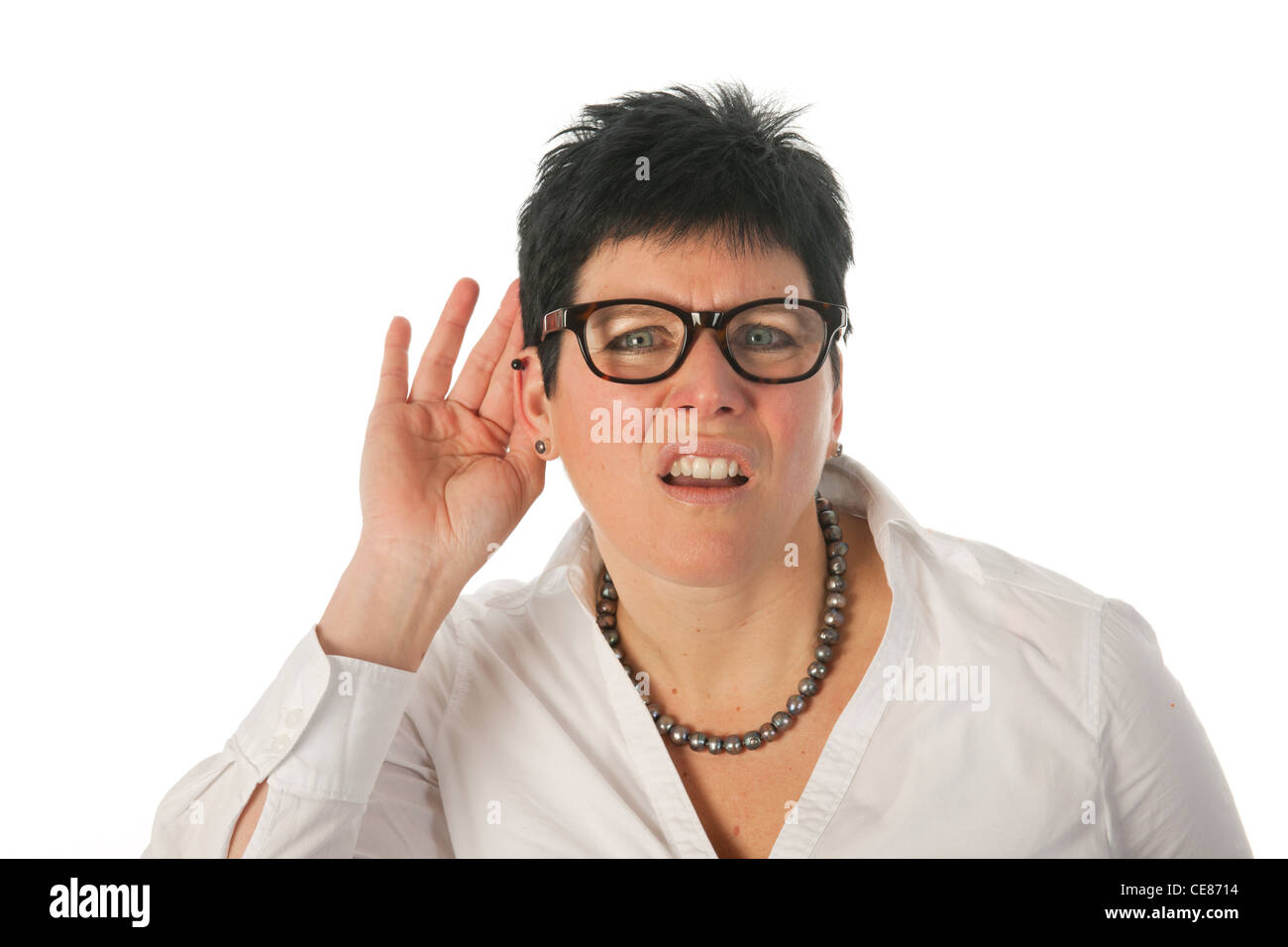Woman is holding her hand behind the ear to hear something Stock Photo ...