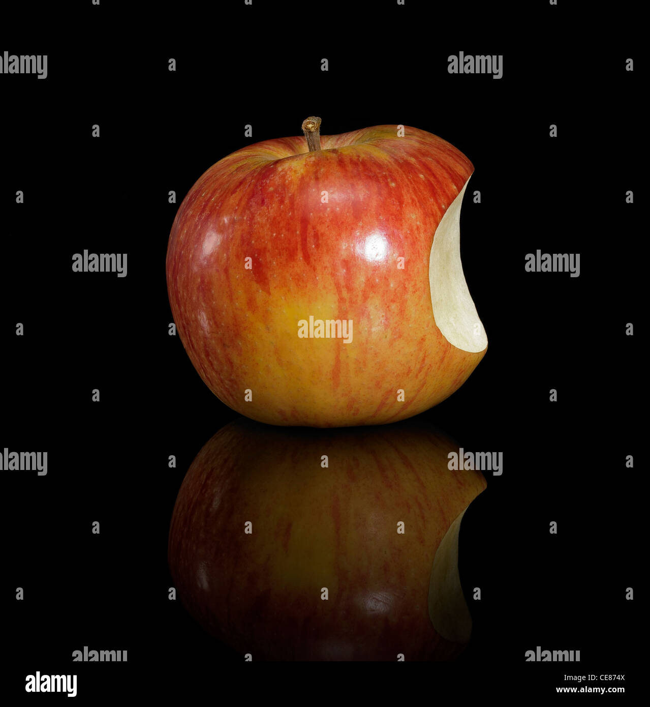 apple with missing part in black reflective back. Looks a little bit ...