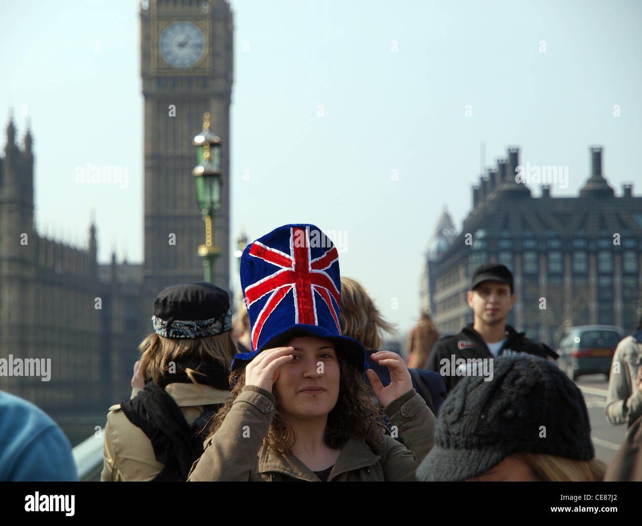 A tourist puts on a funny Union Jack hat in front of Big Ben on ...