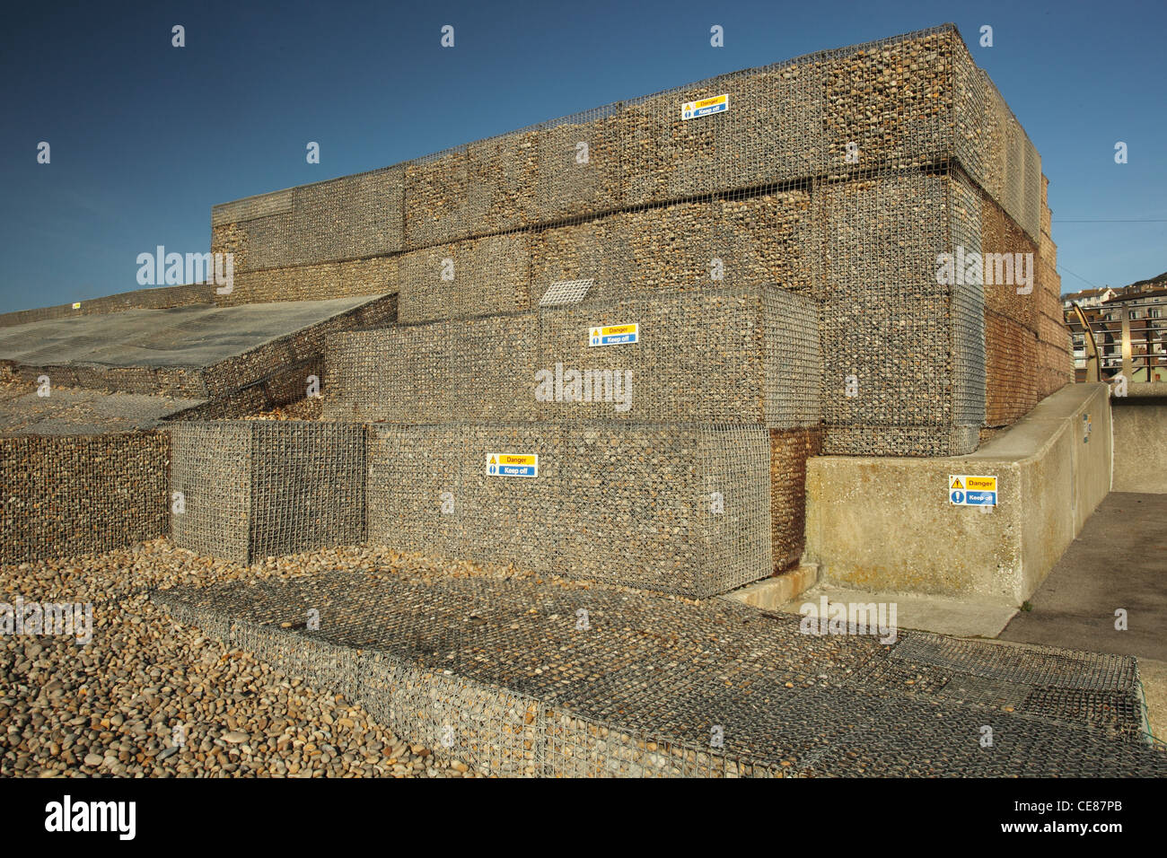 Metal gabions full of shingle, Chesil beach Dorset UK. Coastal defence ...
