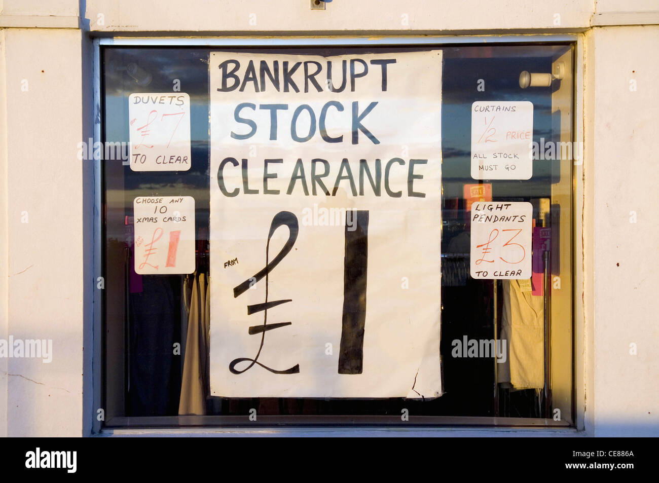 Bankrupt stock clearance sign on shop window Stock Photo - Alamy