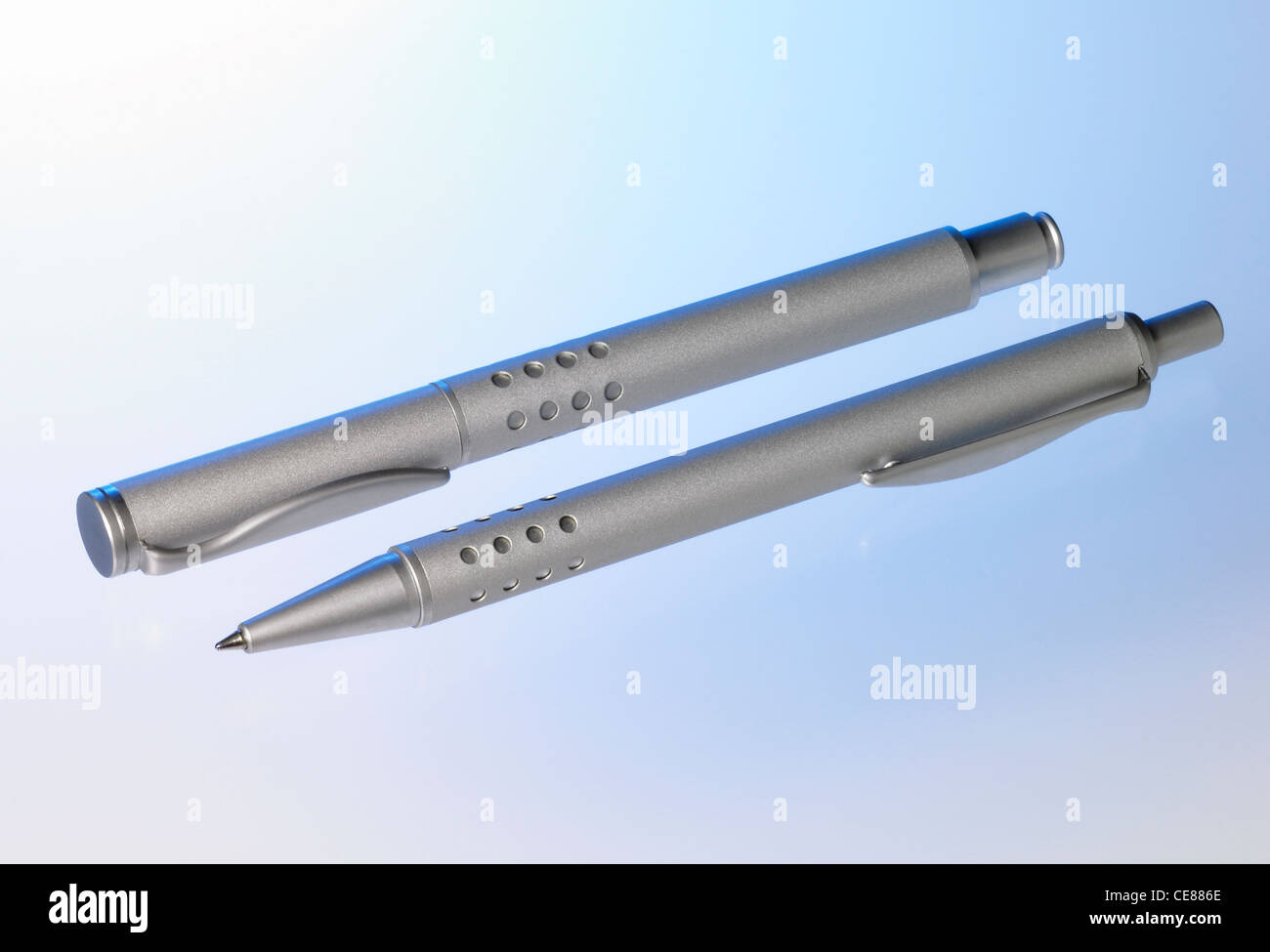 studio shot of 2 ballpens in light colored blue back Stock Photo - Alamy