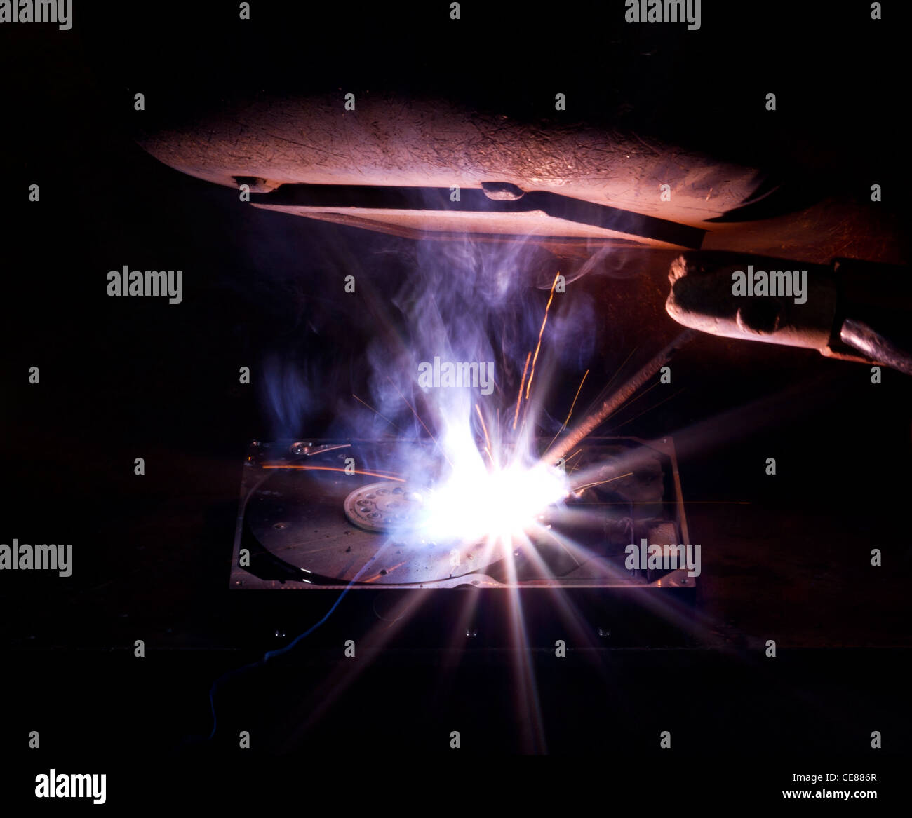 welding scenery with hard disk drive, welding mask detail and flashy ...