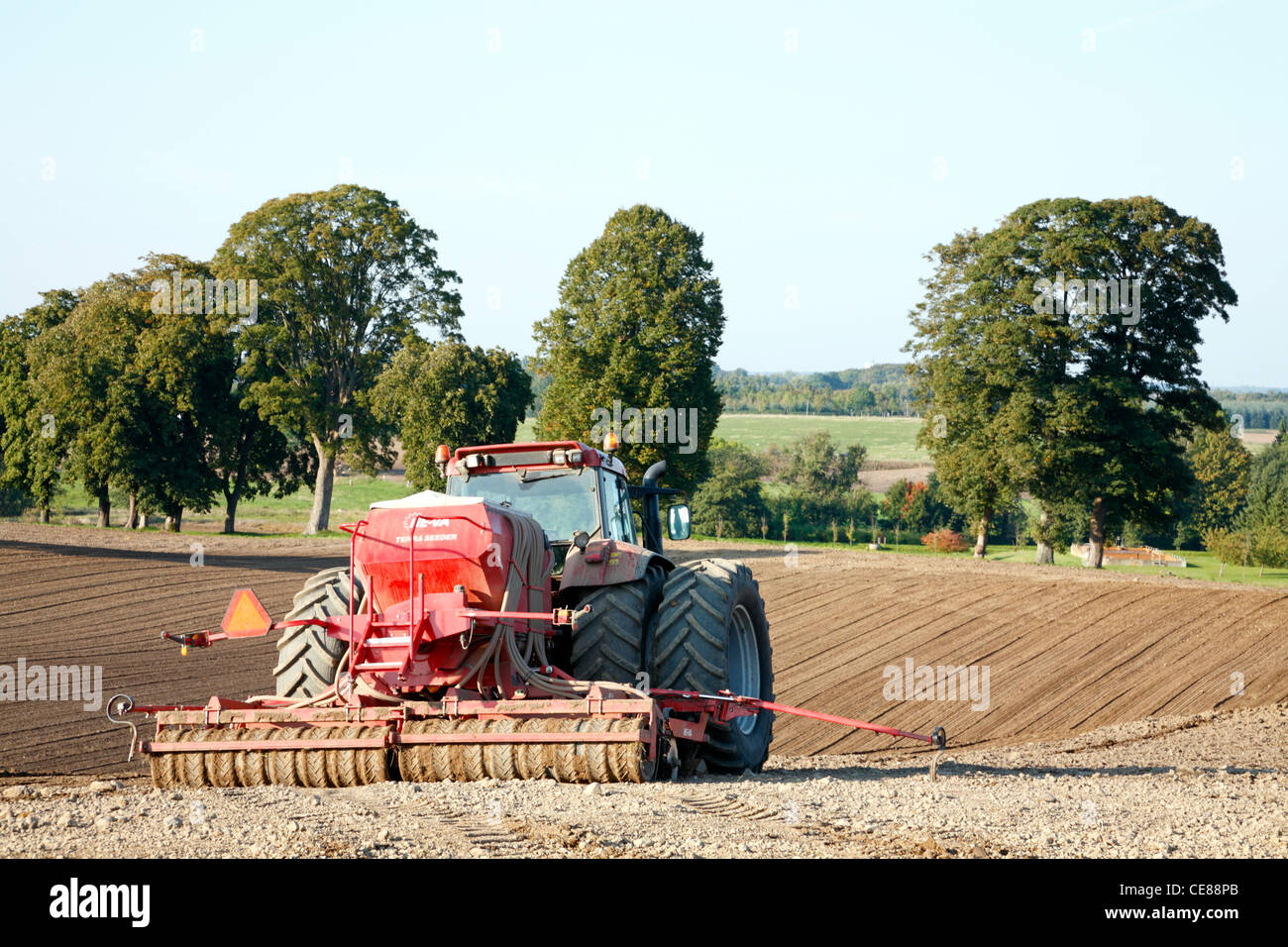 Tractor with sowing machine sowing wheat in the late summer in North ...
