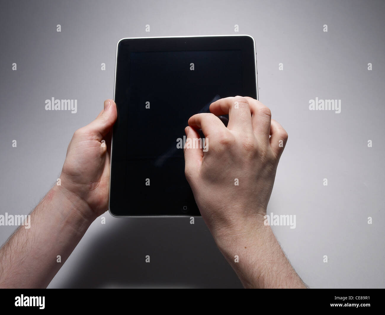 Hands making a pinch motion on an ipsd Stock Photo - Alamy