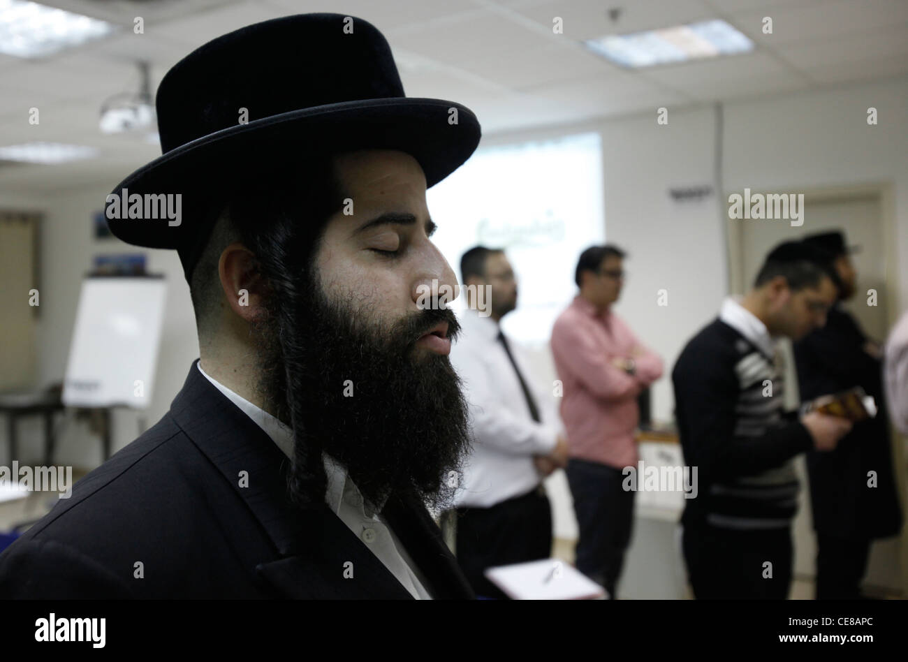 Orthodox religious Jewish men at prayer during a break study in the ...