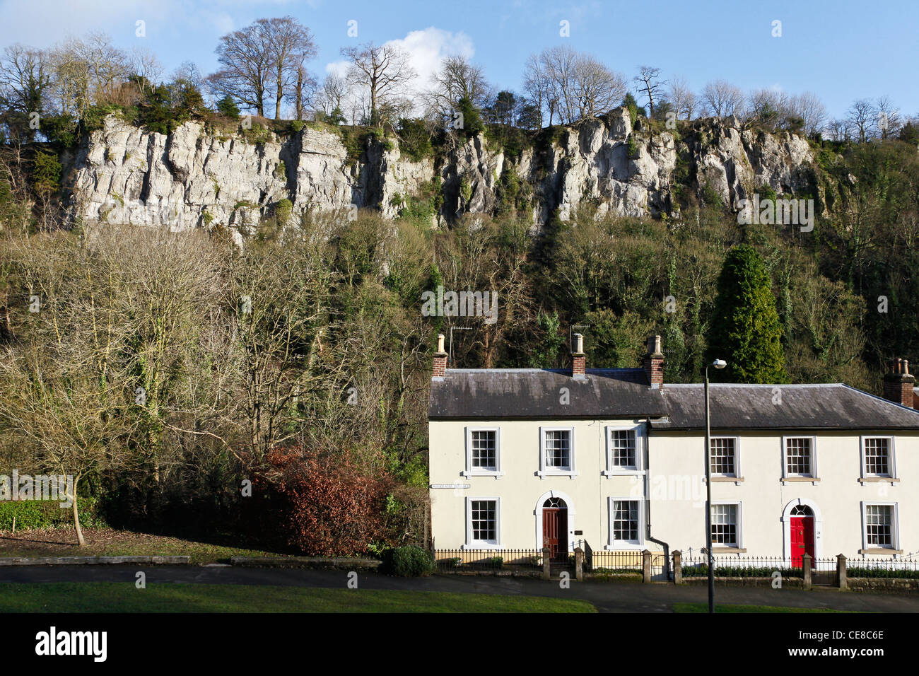Cottages in front of limestone cliffs at Matlock Bath in the Derwent ...