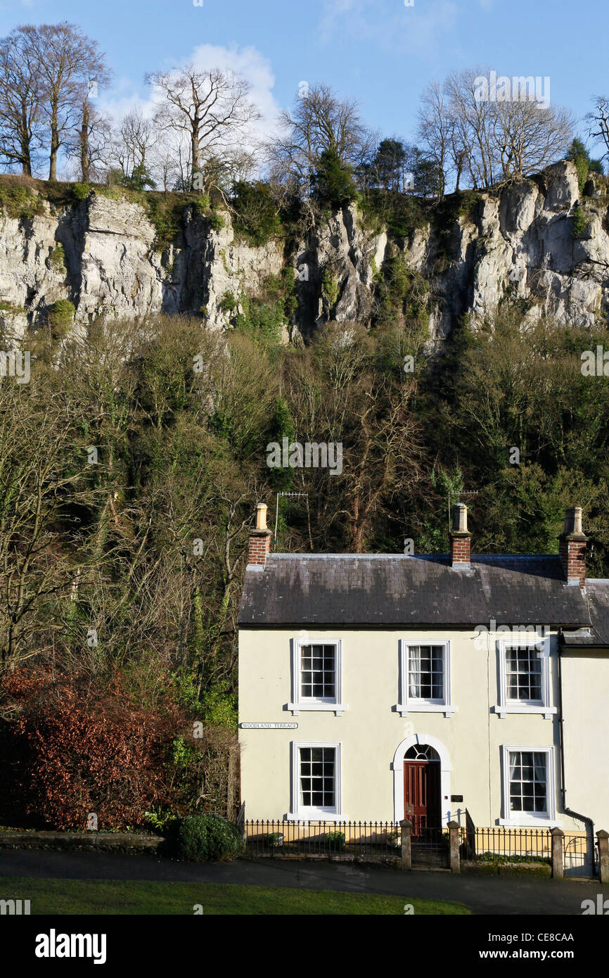 Cottages in front of limestone cliffs at Matlock Bath in the Derwent ...