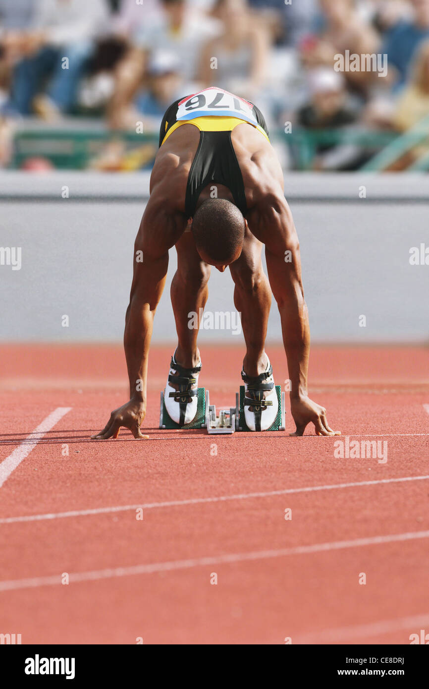 Runner Preparing To Leave Starting Blocks Stock Photo - Alamy
