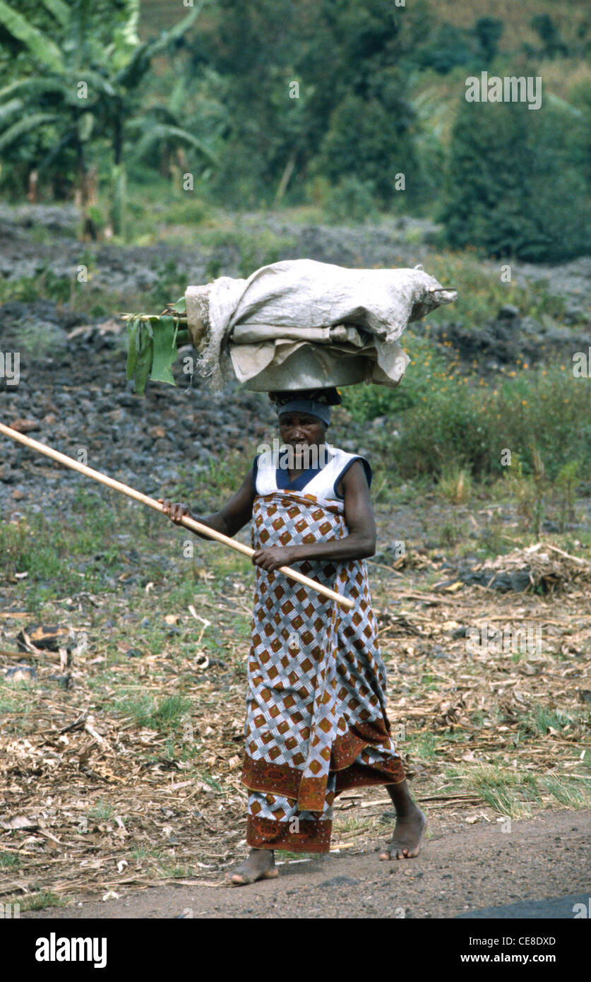 Woman in Zaire carrying wood on her head Stock Photo - Alamy