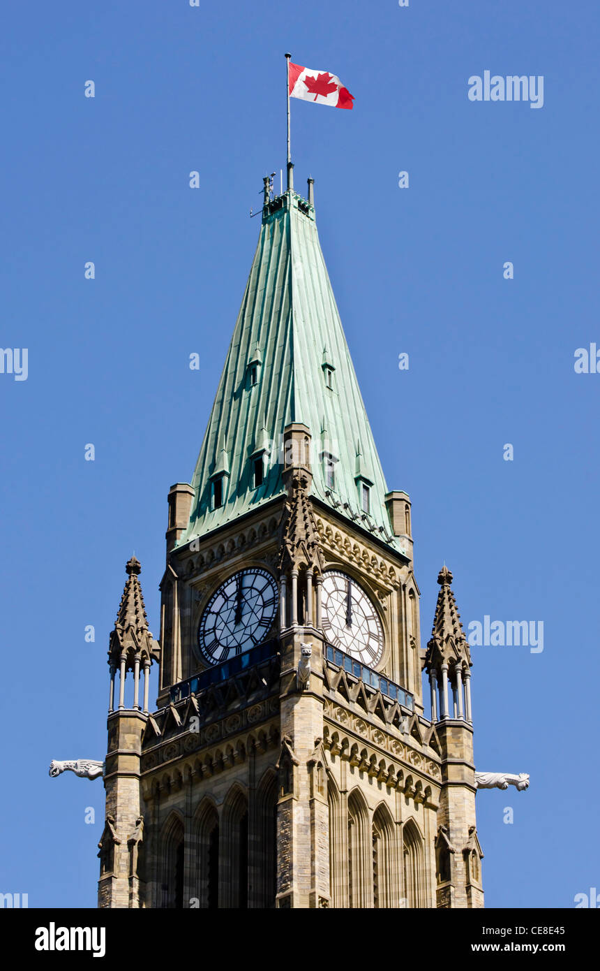 The Canadian Parliament Peace Tower with flag at noon in Ottawa Canada ...