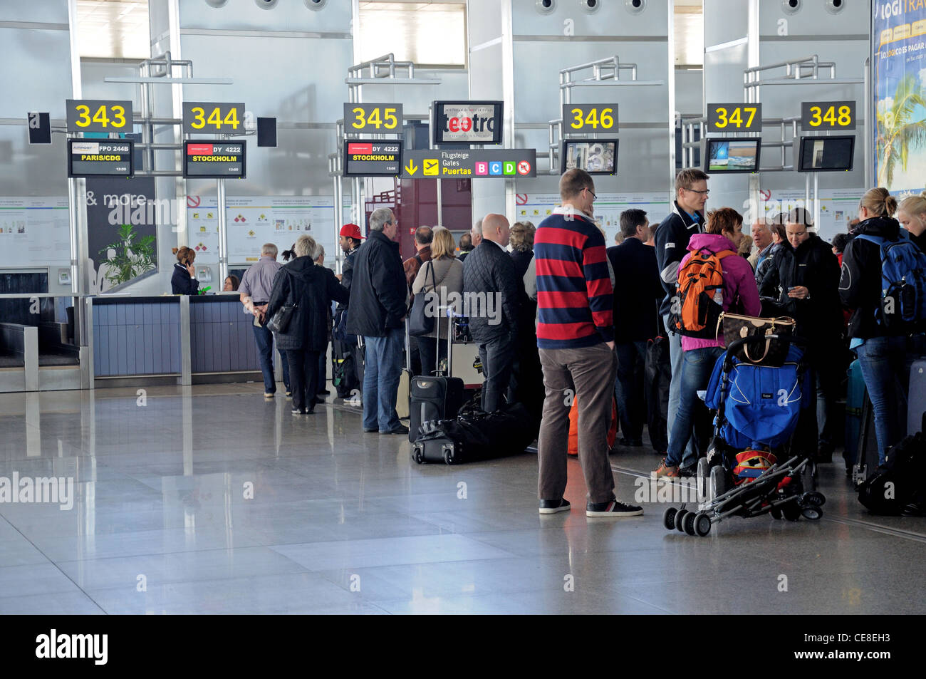Passengers waiting in Check-in queue, Terminal 3, Malaga airport ...