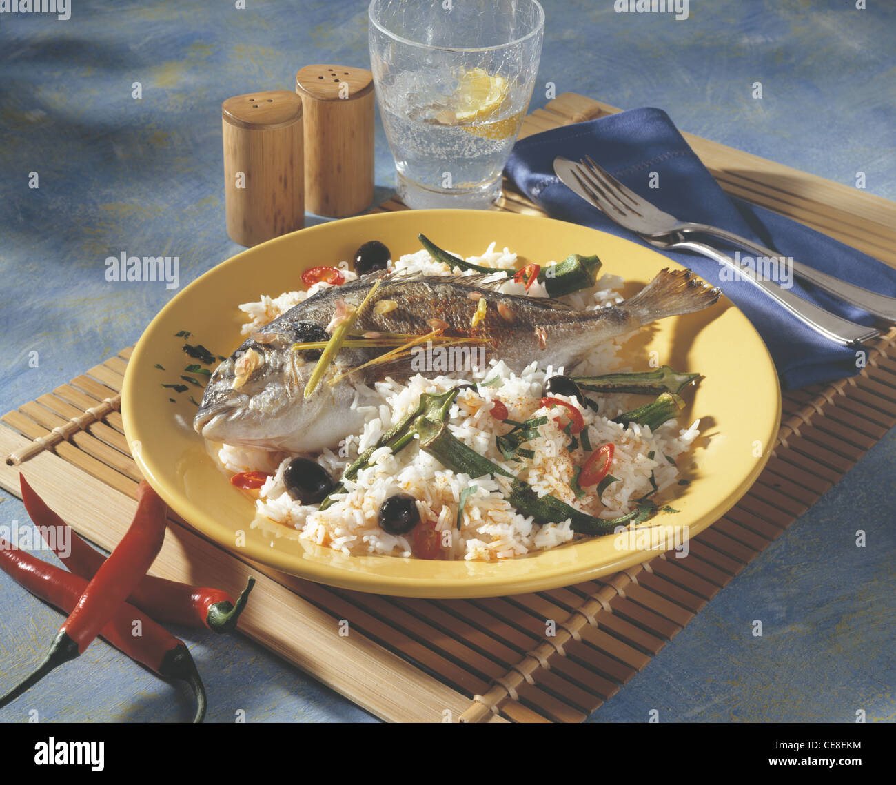 Basmati rice with okra sprouts and fried gilthead seabream Stock Photo ...