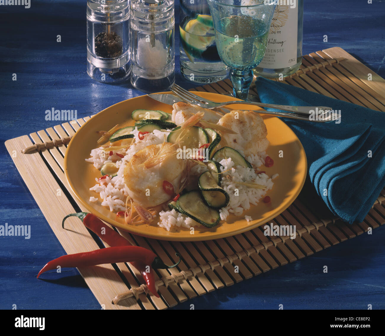 Basmati rice with zucchini and fried monkfish filet Stock Photo - Alamy