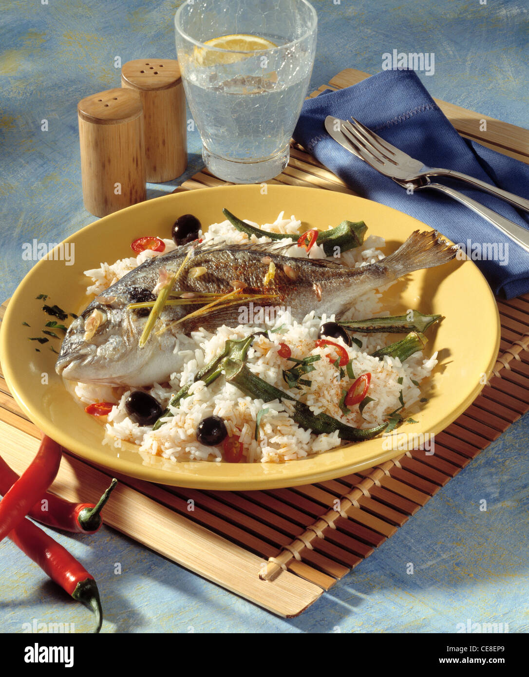 Basmati rice with okra sprouts and fried gilthead seabream Stock Photo ...
