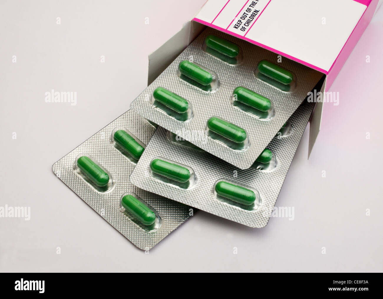 Box of green capsules in blister packs Stock Photo - Alamy