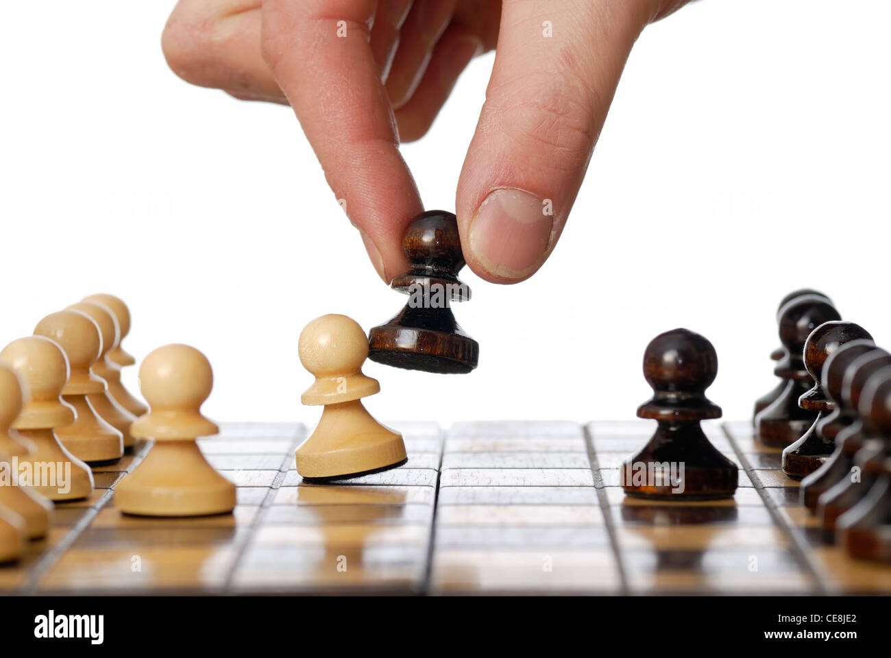 Hand moving black chess piece taking a white pawn Stock Photo - Alamy